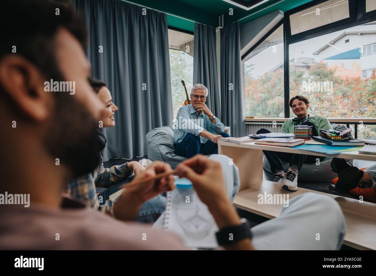 Professor engaging with students in a comfortable study space Stock ...