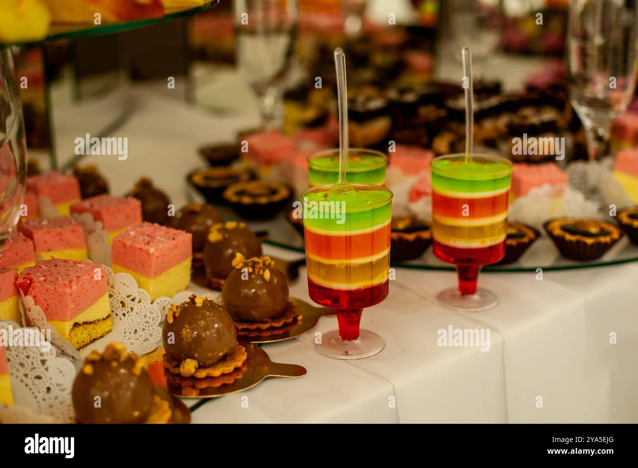 Colorful Dessert Table Featuring Layered Jello and Assorted Treats ...