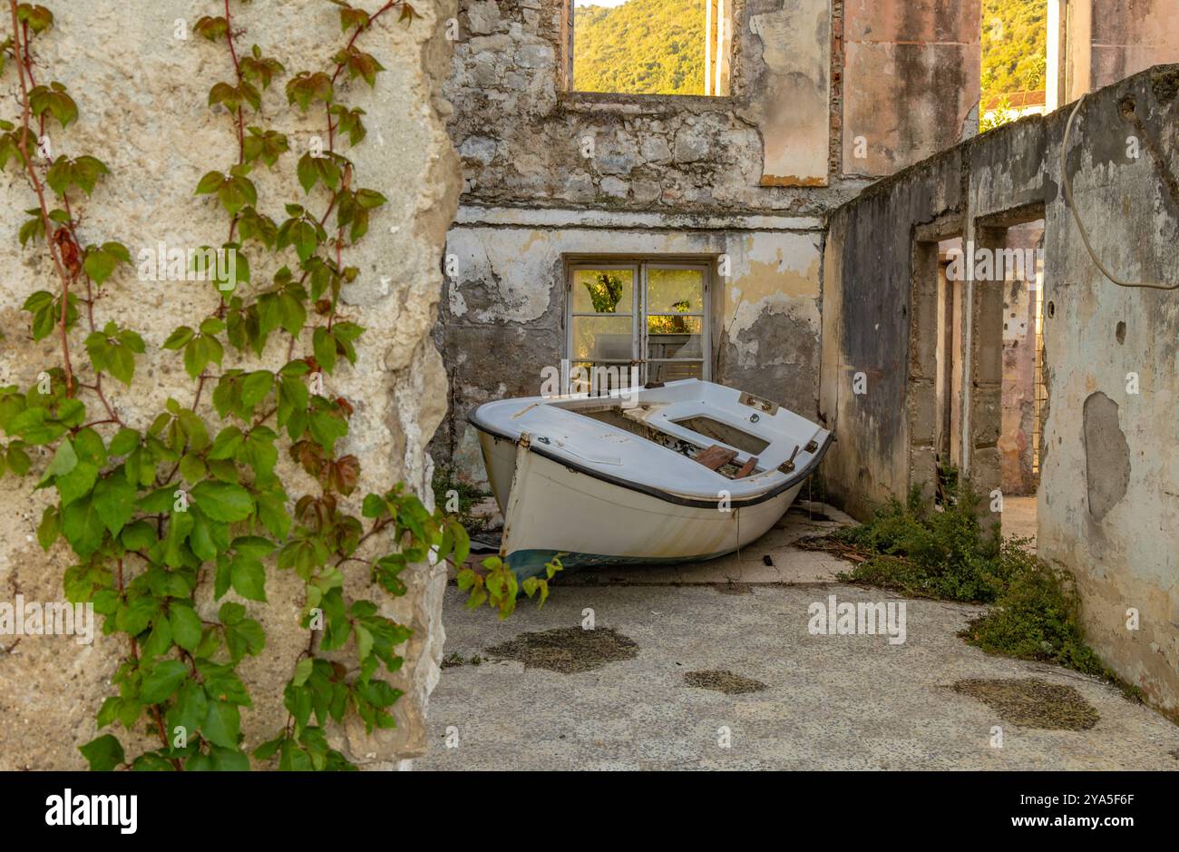A leaky old fishing boat washed ashore in the port of Trpanj Stock ...