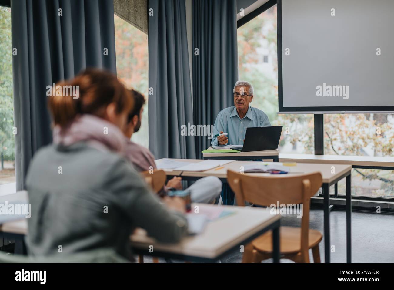 Students attending a class in a cozy, modern classroom setting Stock ...