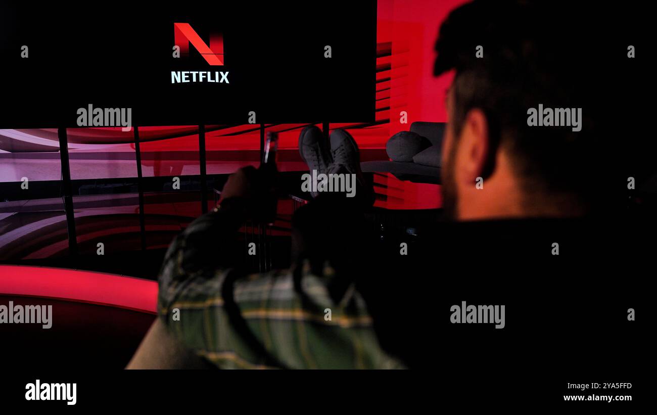 A man enjoy watching netflix on huge tv screen Stock Photo - Alamy