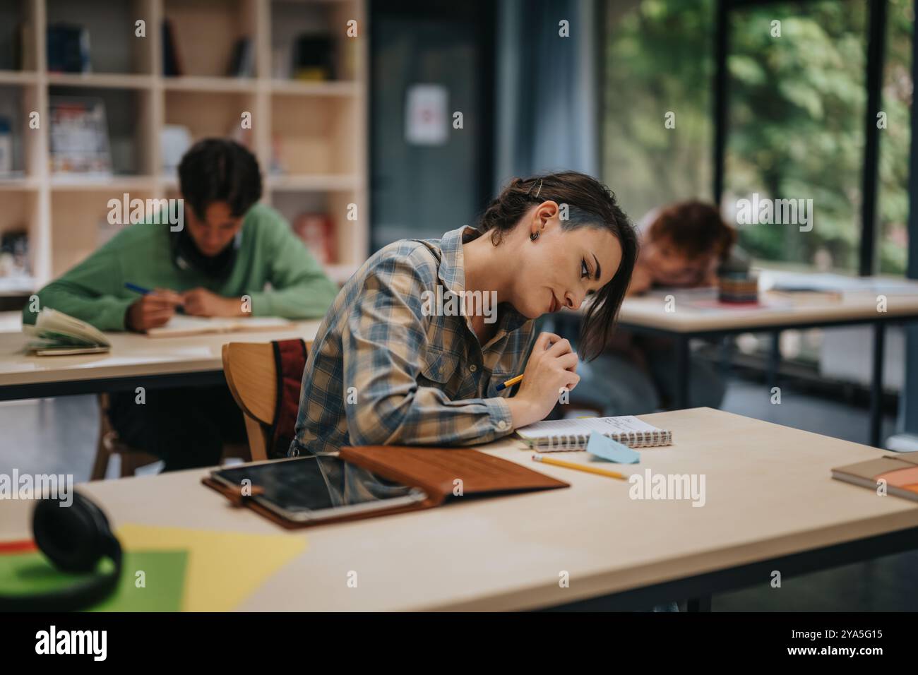 Students taking notes and studying in a modern classroom. Engaged ...