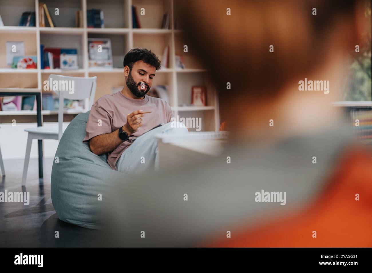 Professor engaging with students in a relaxed classroom setting Stock ...