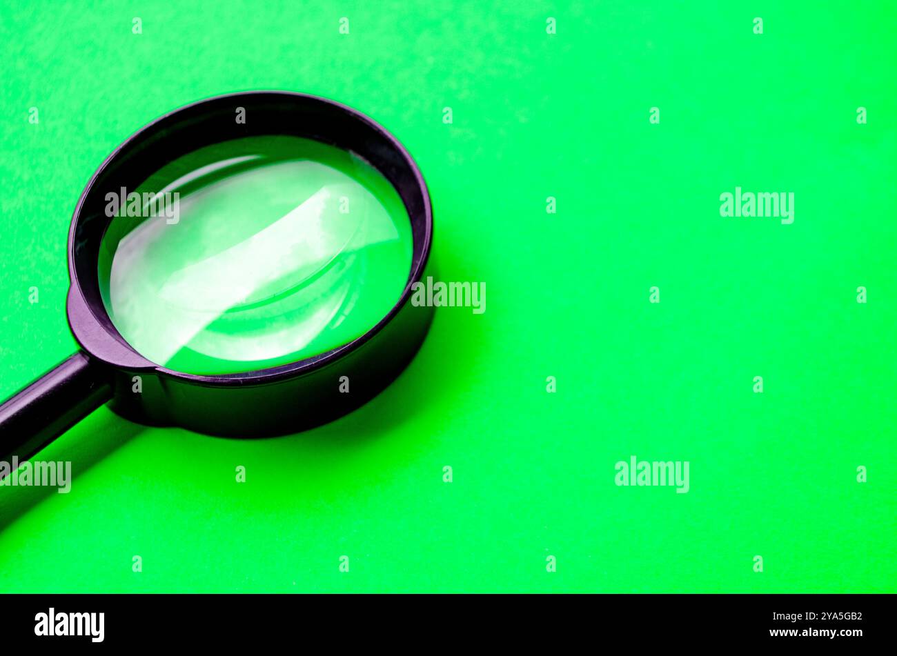 Magnifying glass on green cover background with customizable space for ...