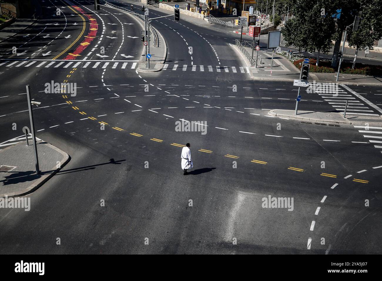 RELIGION-ISRAEL/YOM KIPPUR A person walks on a crosswalk at an empty ...