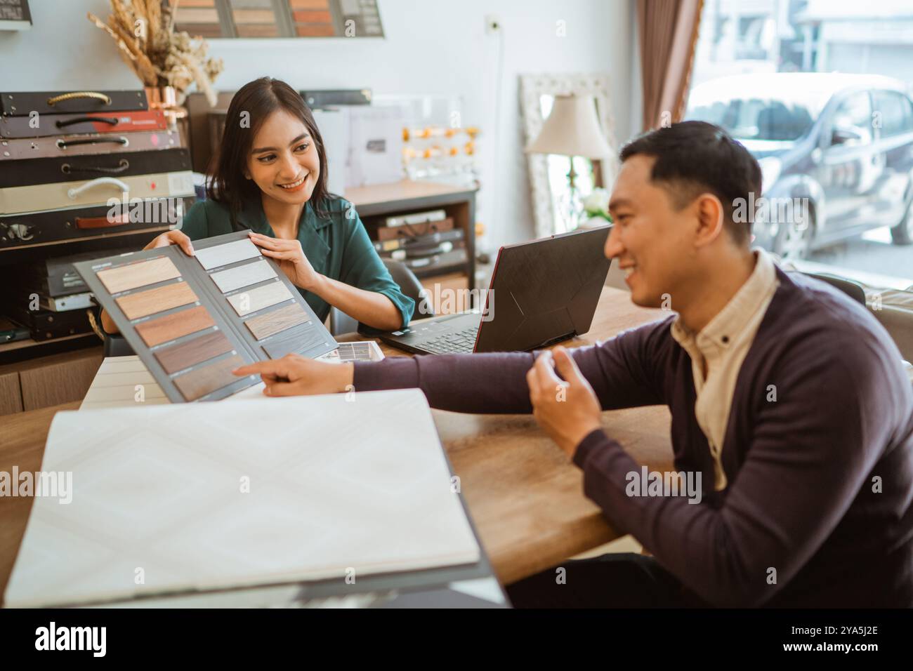 female shopkeeper smiling while giving service to the male customer ...