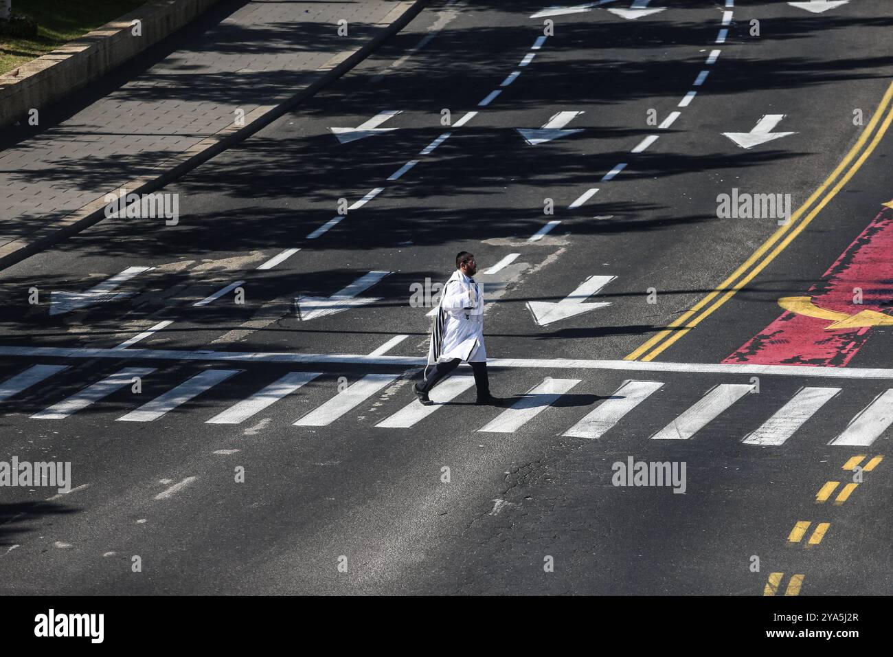 RELIGION-ISRAEL/YOM KIPPUR A person walks on a crosswalk at an empty ...