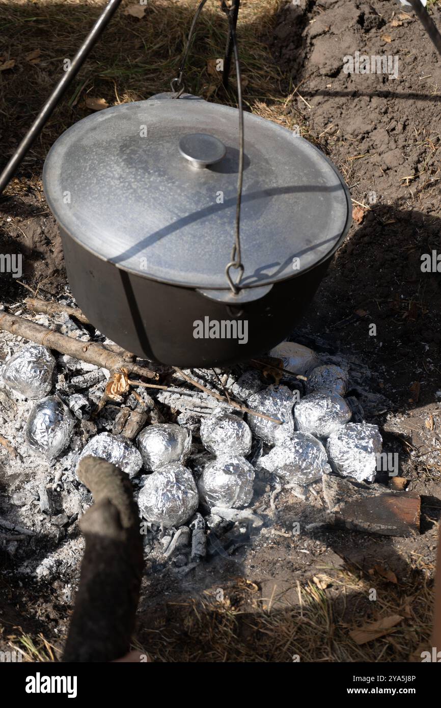 Campfire cooking boiling potatoes hi-res stock photography and images ...