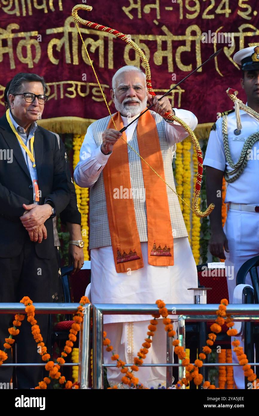 Indian Prime Minister Narendra Modi takes an aim of the arrow at the ...