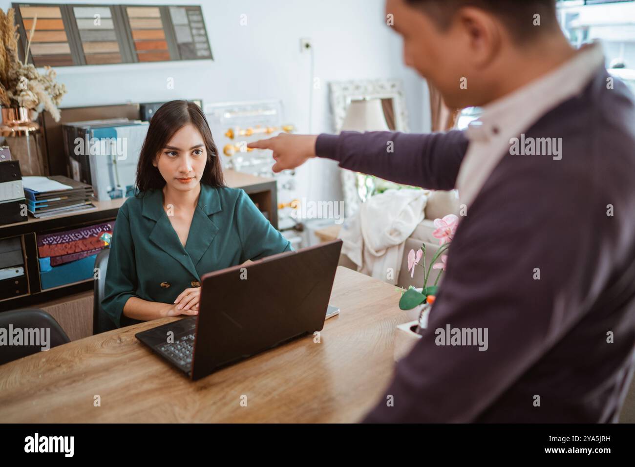 frustrated female shopkeeper glared to the male shop owner that ...