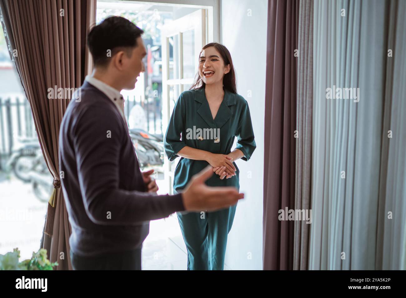 beautiful asian customer laughing while entering the interior shop ...