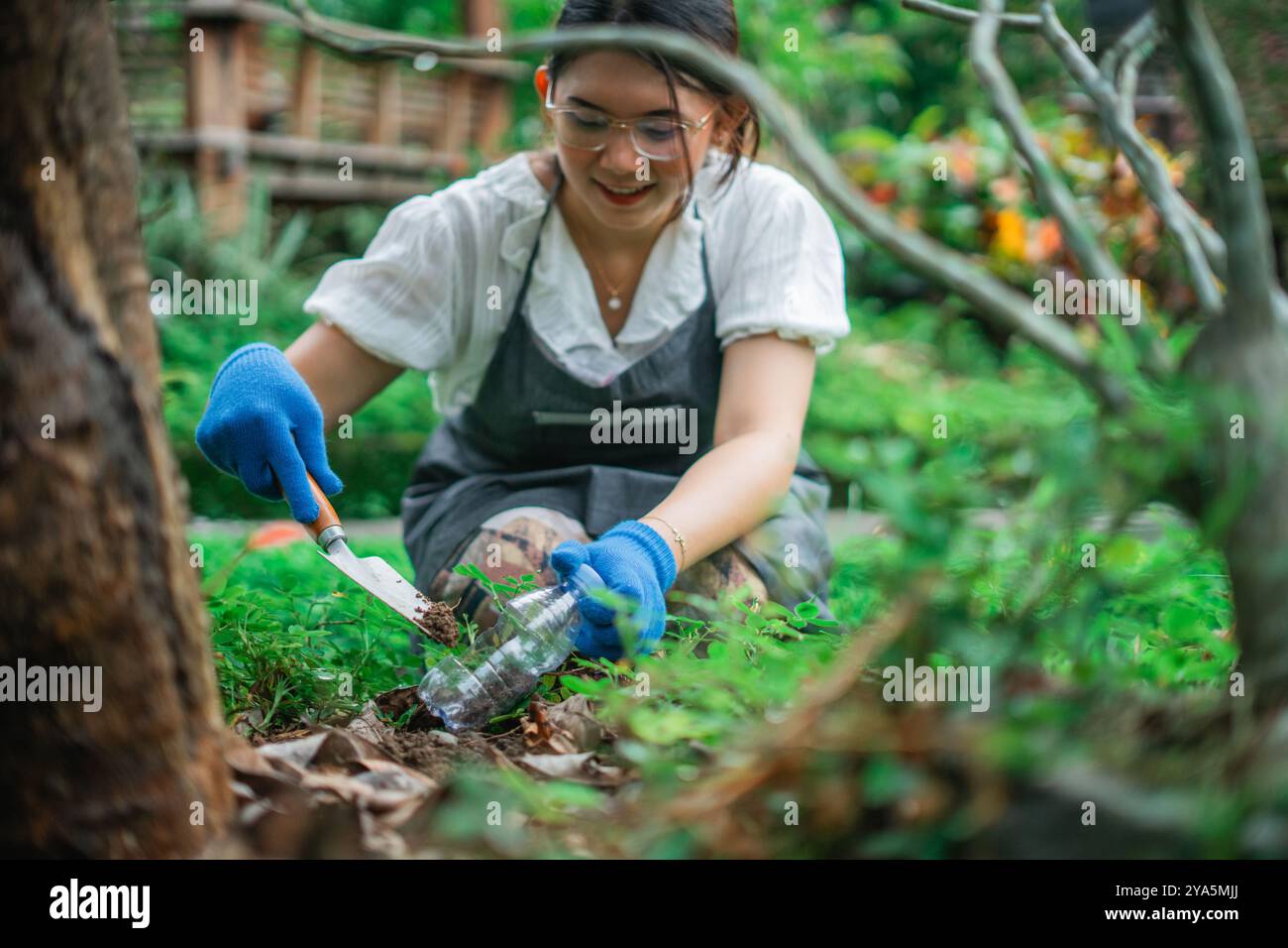 happy asian woman planting using recycled plastic bottle pot Stock ...
