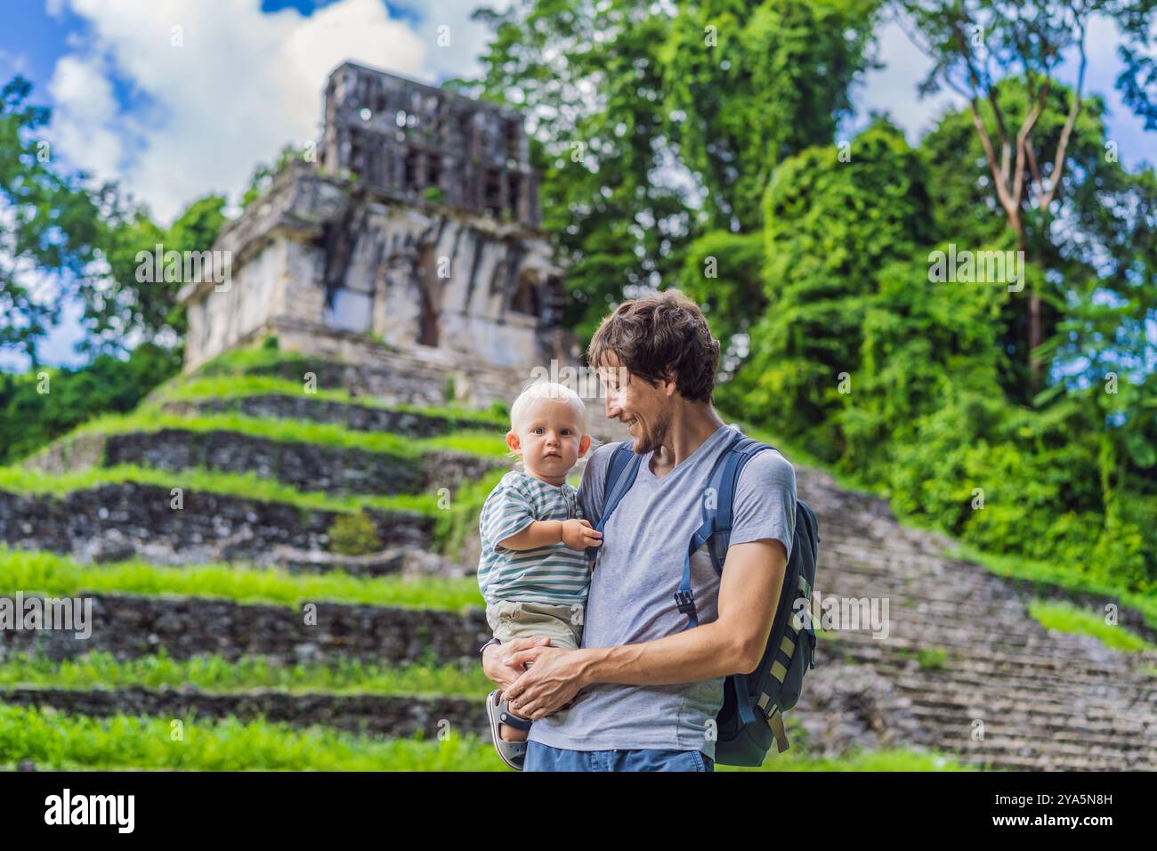Father with his toddler son exploring the ancient pyramids of Palenque ...