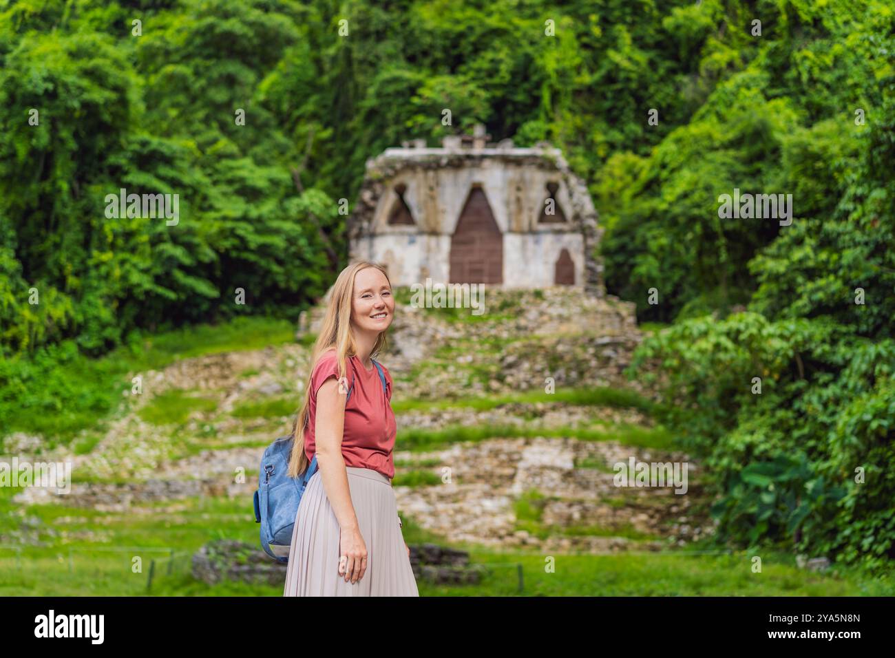 Female tourist exploring the ancient pyramids of Palenque, Mexico ...