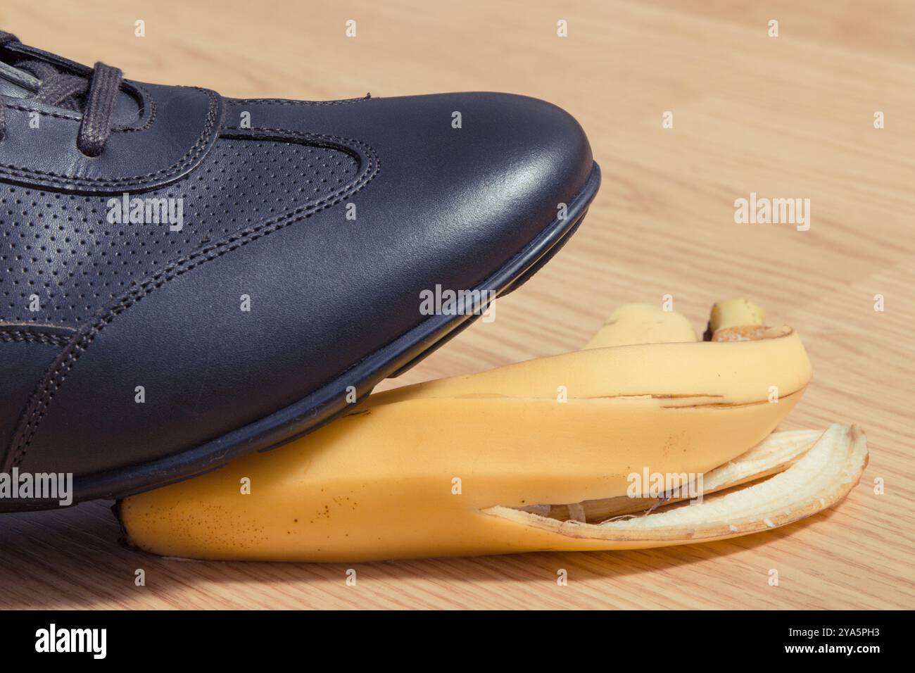 Foot in leather comfortable shoe before slipping on banana peel Stock ...