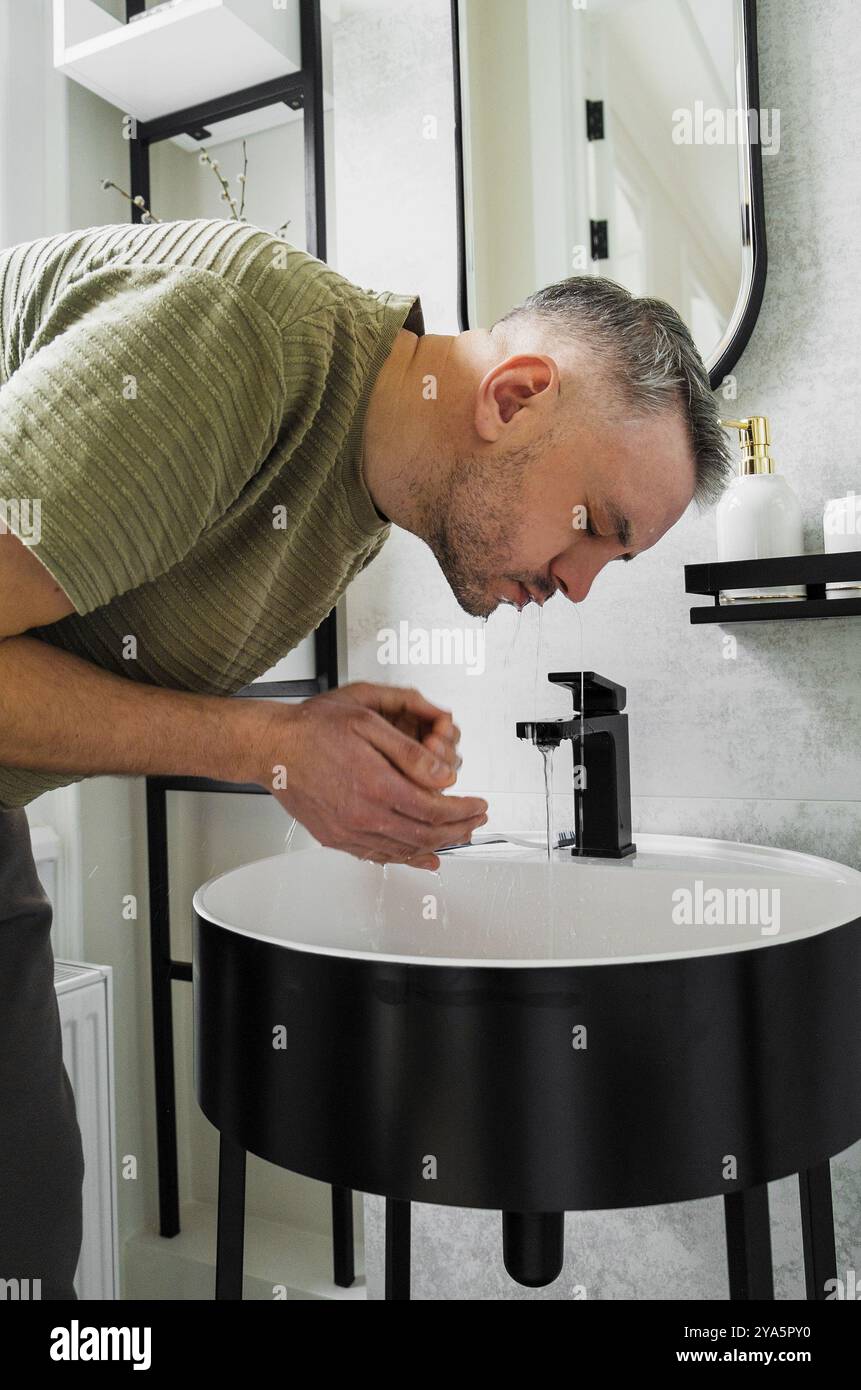 Adult bending over sink hi-res stock photography and images - Alamy