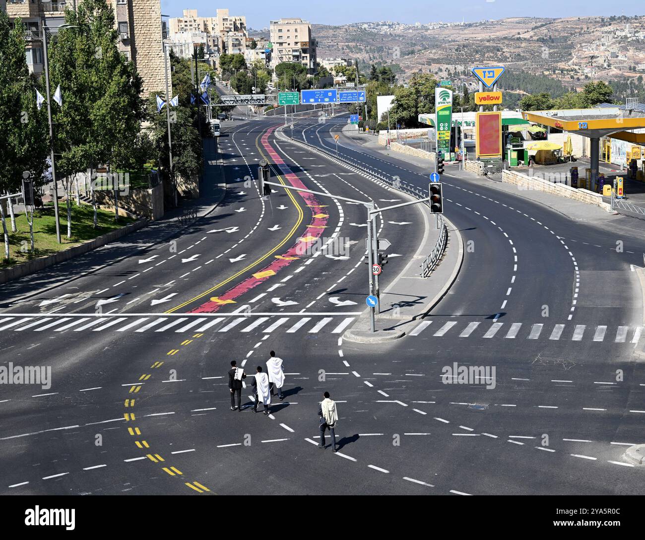 Jerusalem, Israel. 12th Oct, 2024. Ultra-Orthodox Jews walk on an empty ...