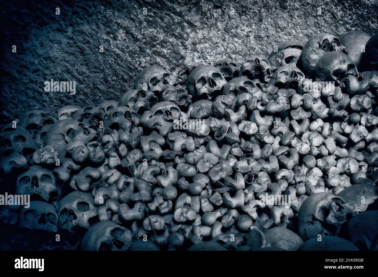 Pile of bones and skulls inside a cave, concept for a Halloween project ...