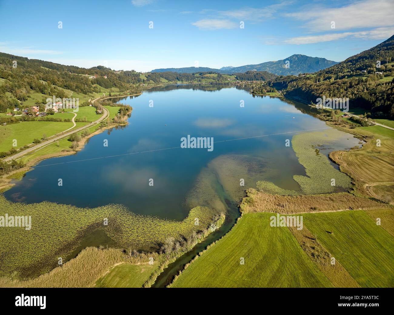 Aerial landscape in the Allgaeu Alps with lake Alpsee next to ...