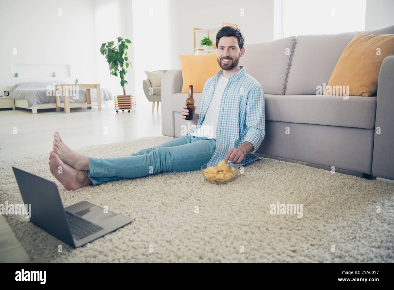 Photo of handsome guy staying home in his new house indoors living room ...