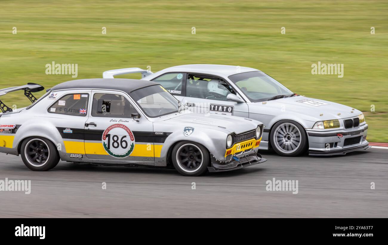 Colin Claxton in his Ford Escort battles in out with the BMW M3 of ...