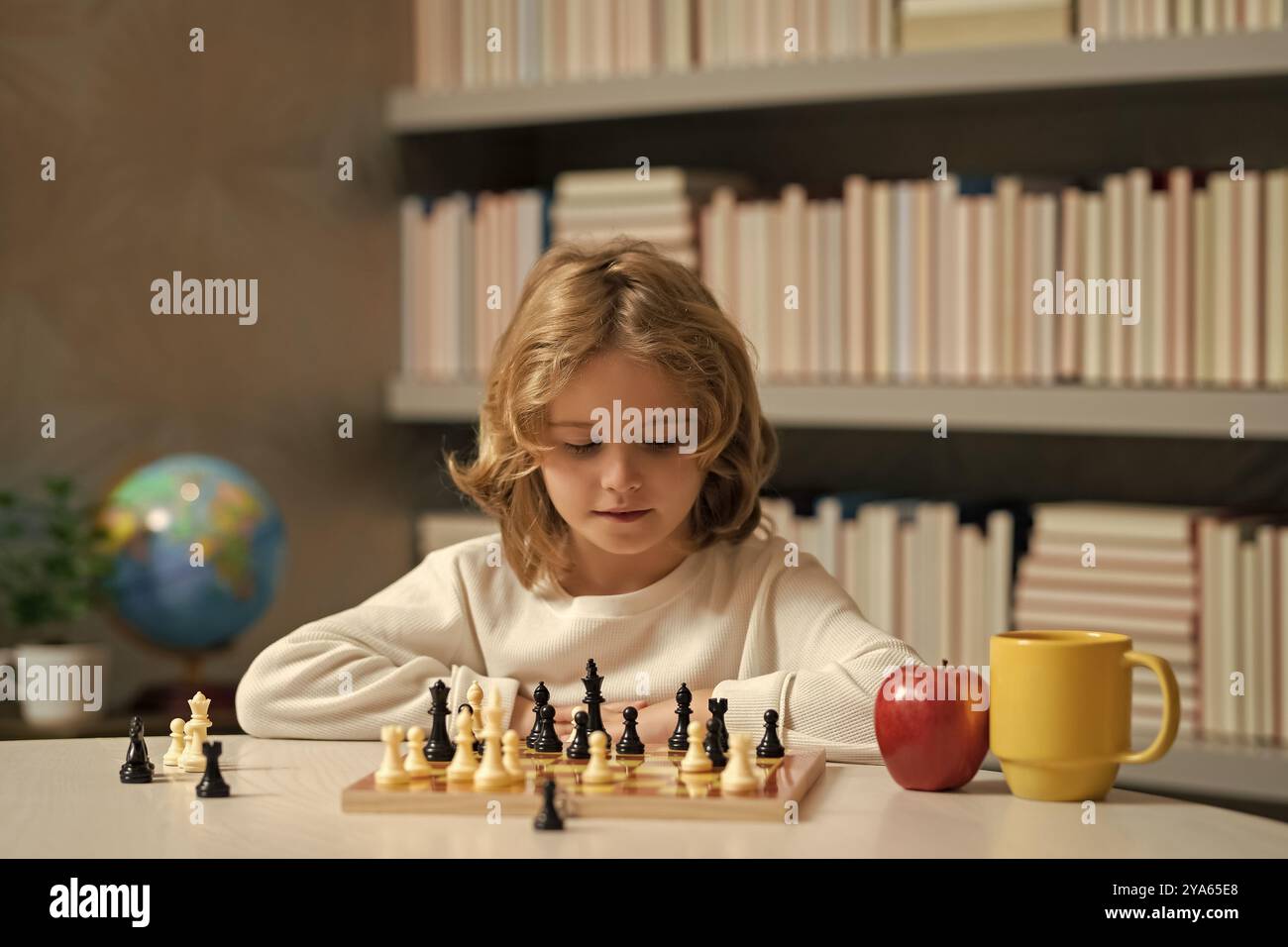 Child boy developing chess strategy, playing board game. Intelligent ...