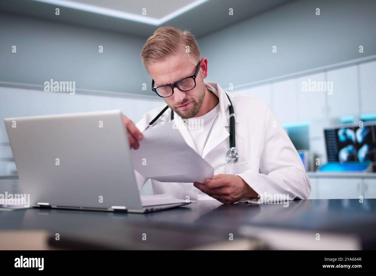 Shocked Medical Doctor Reading Document At Desk In Office Stock Photo ...