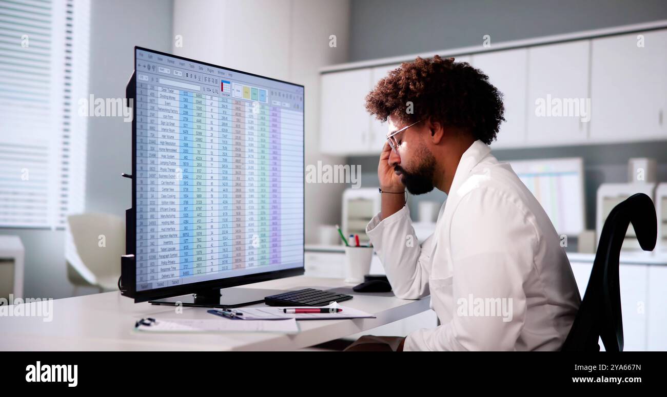 Data Analyst African Man Using Spreadsheet On Computer Stock Photo - Alamy