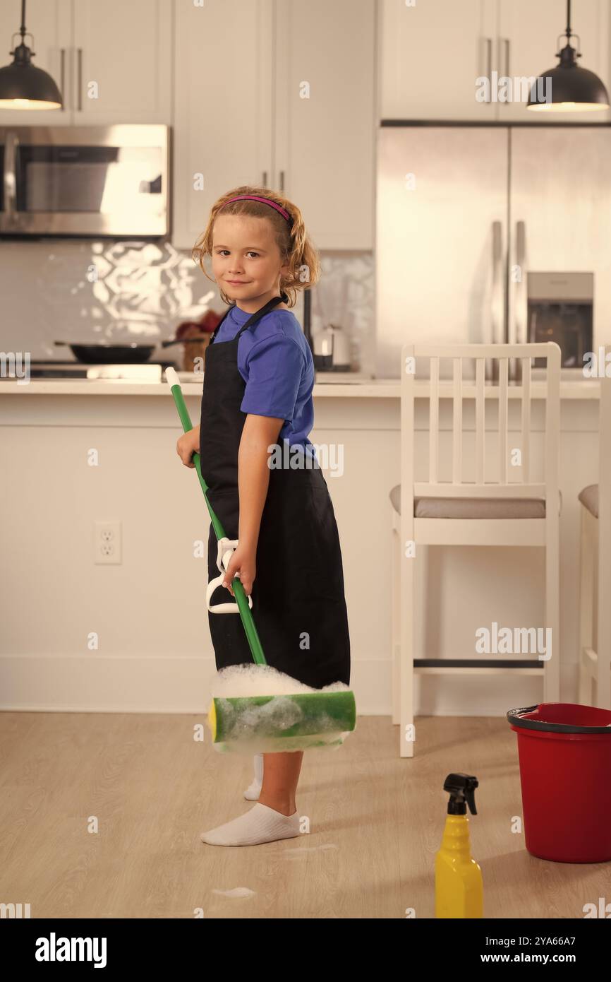 Little kid cleaning at home. Child doing housework having fun. Portrait ...