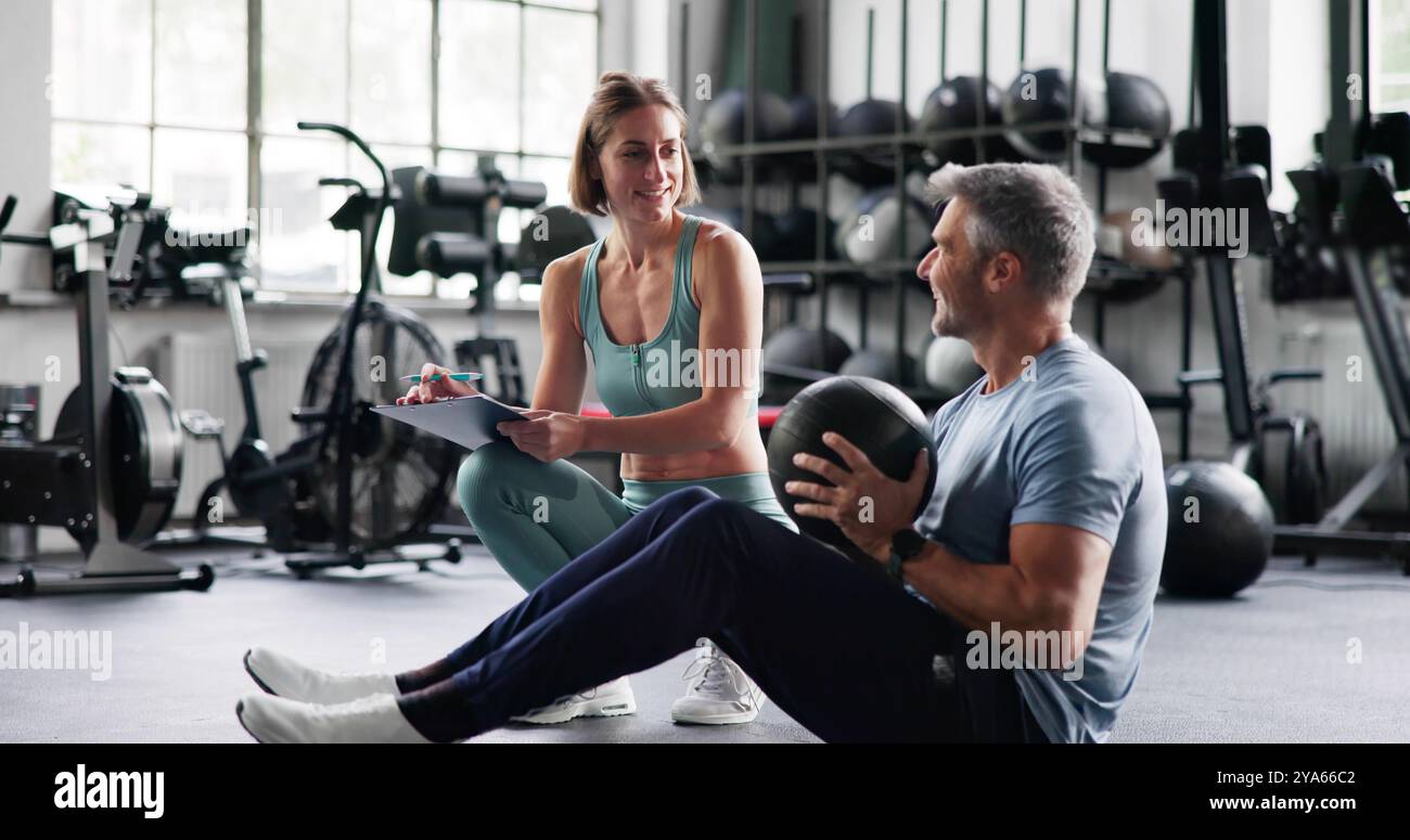 Personal Trainer Showing Abdominal Sit Up Workout In Gym. Physical ...
