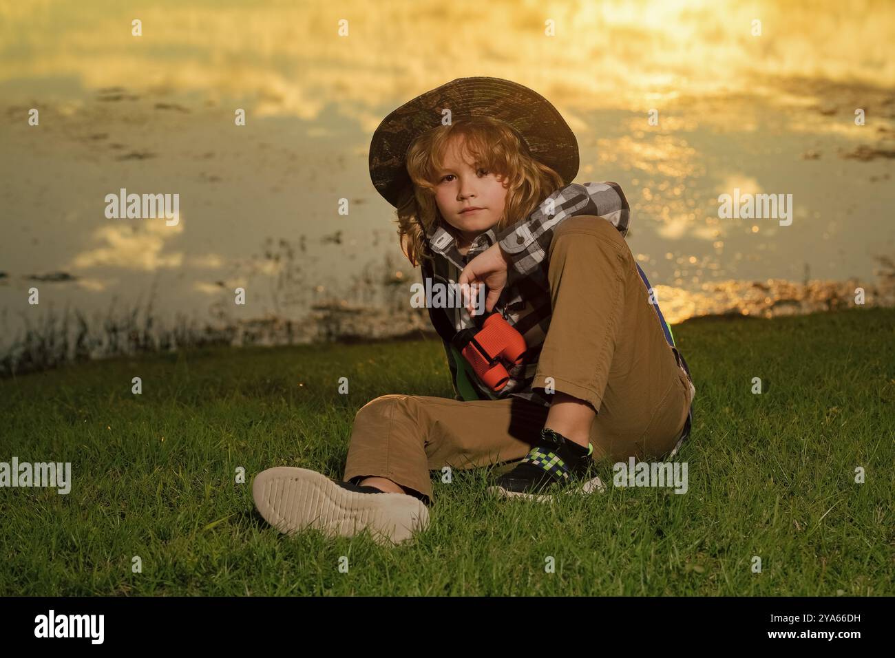 Scout boy wearing explorer hat and backpack outdoor. Explorer and adventure with binocular Stock ...