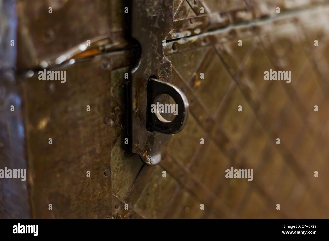 A close up view of a metallic object that prominently features a hole ...