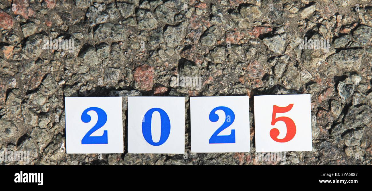 Numbers of 2025 year. Paper square numbers on the stone road background ...
