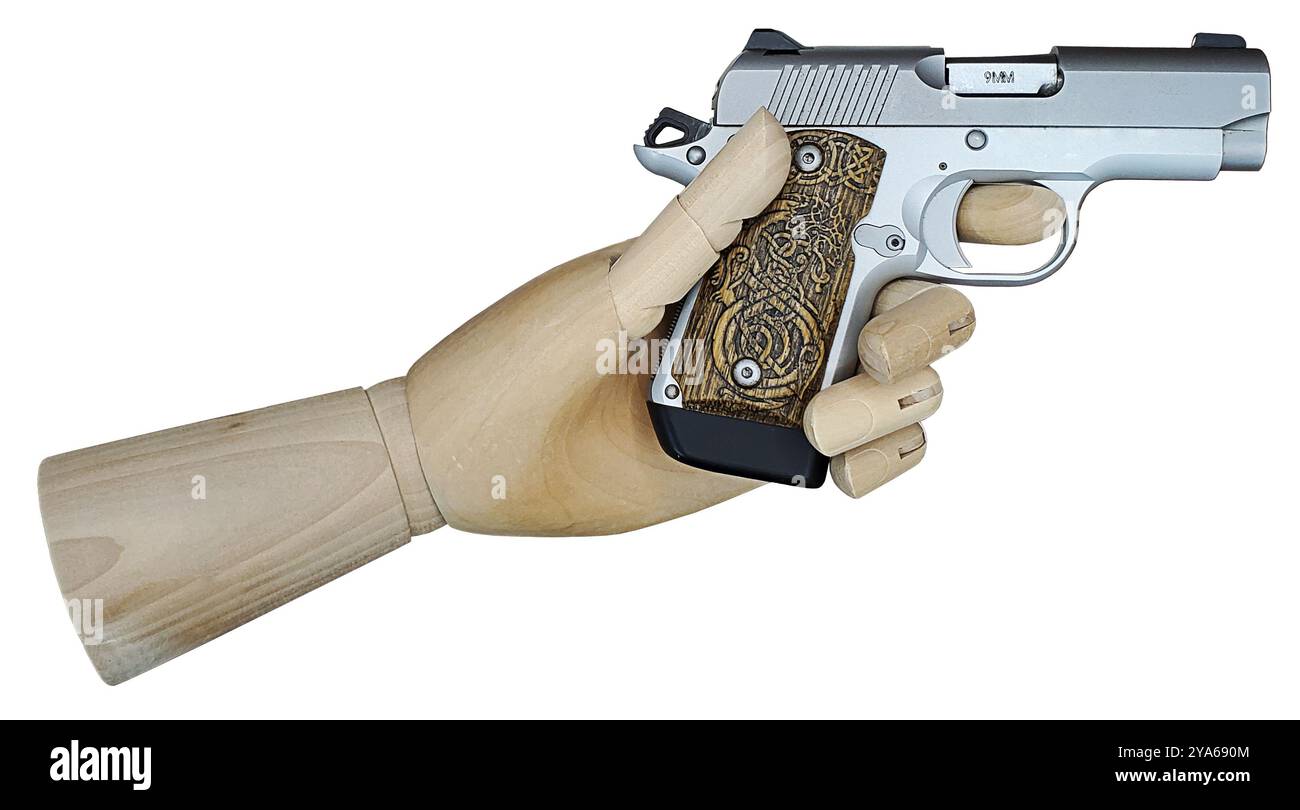 Wooden Hand Holding a Silver metal gun with Celtic Engraved grip Stock ...