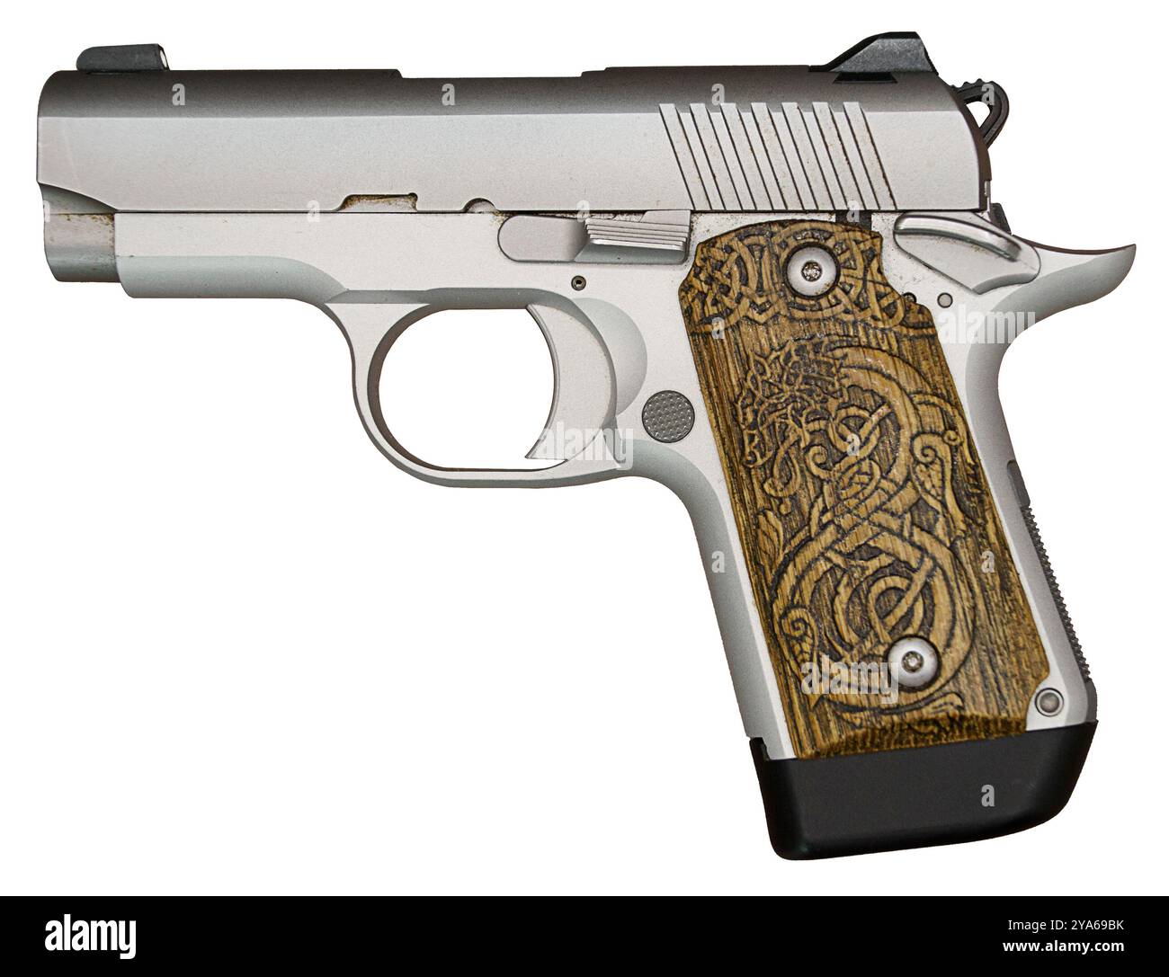 Silver metal gun with Celtic Engraved grip from the left Stock Photo ...