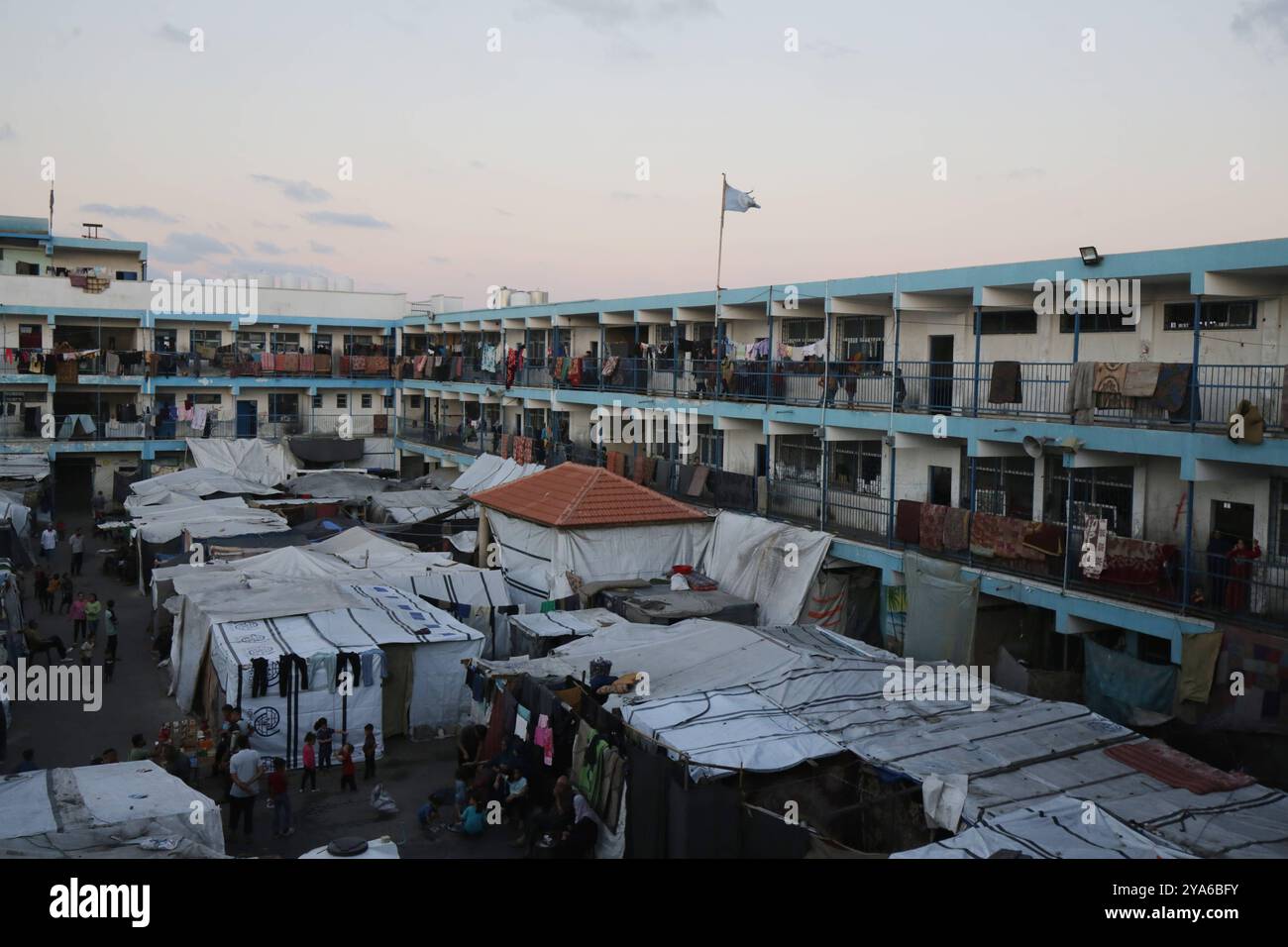 Palestinians take shelter in the UNRWA school, and the tents they have ...