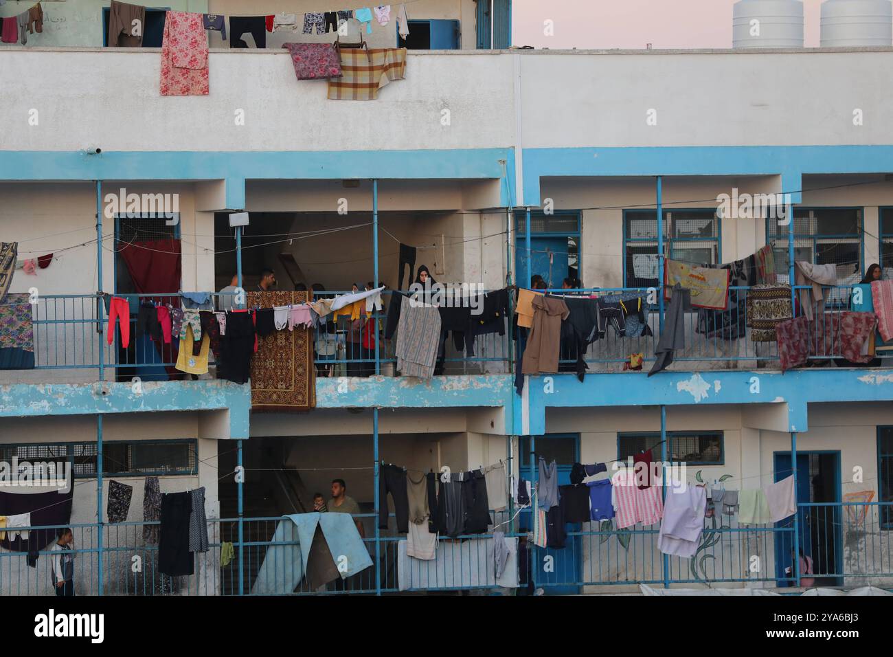 Palestinians take shelter in the UNRWA school, and the tents they have ...