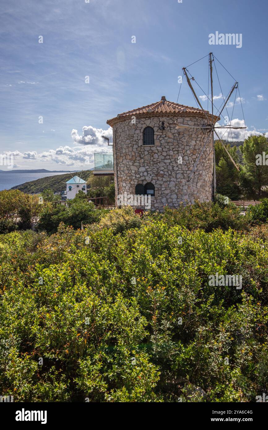 A typical Greek windmill at night. It stands on a cliff in the ...