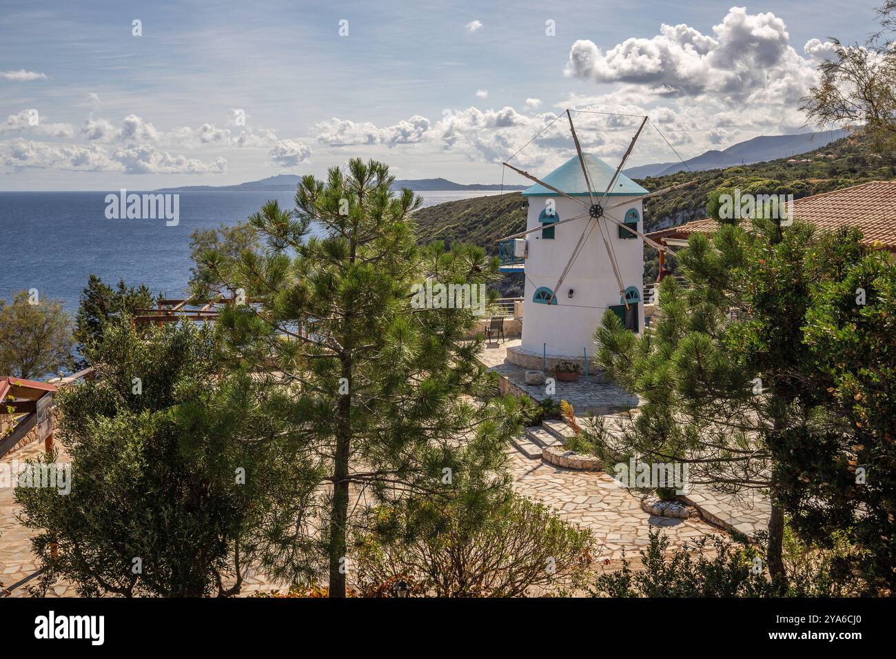 A typical Greek windmill at night. It stands on a cliff in the ...
