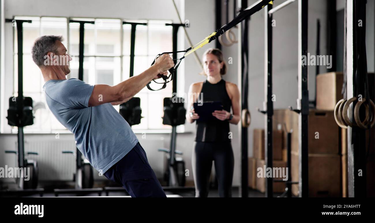 Sport Exercise In Gym. Fitness Athlete Doing Suspension Training ...