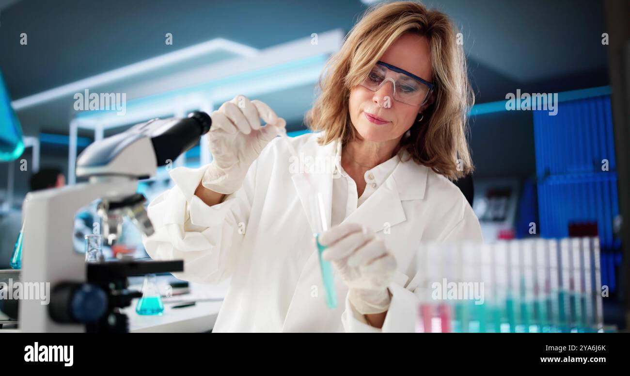 Doctor doing research using microscope hi-res stock photography and ...
