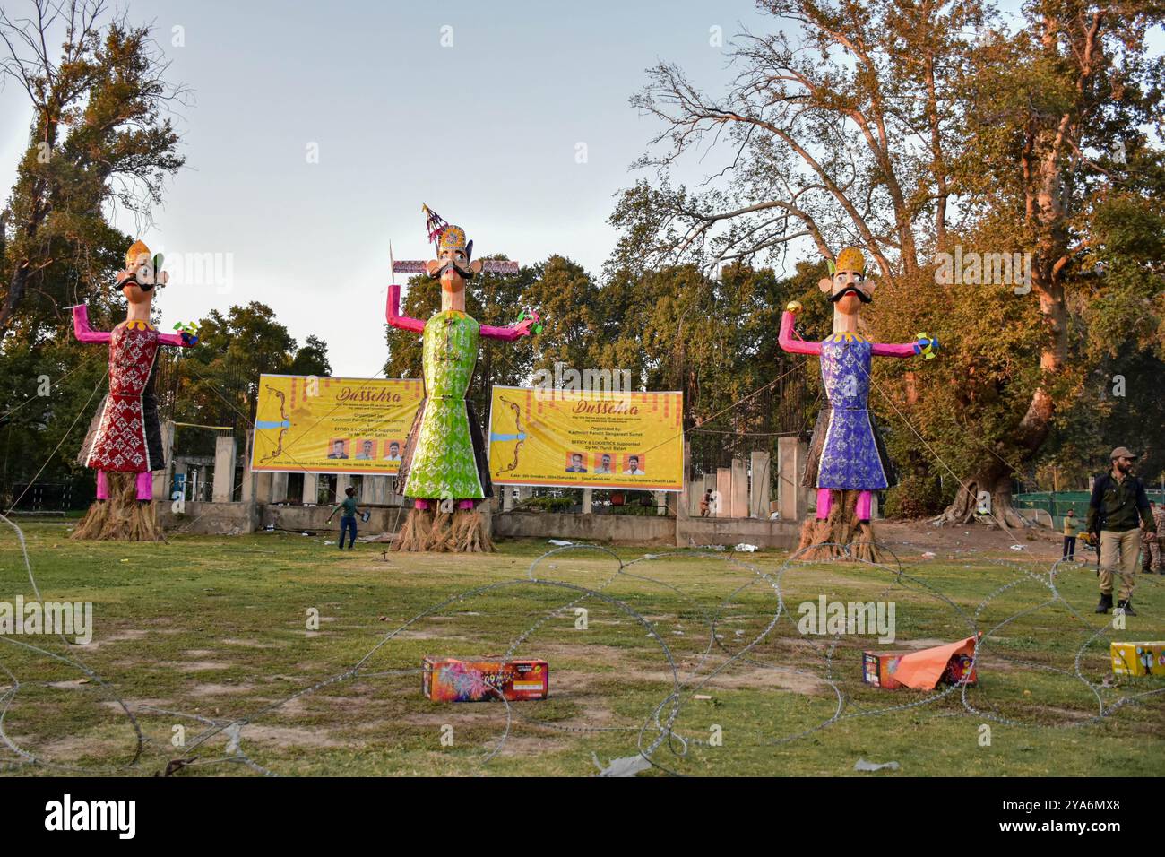 A policeman walks near the effigies of the demon king Ravana, his son ...