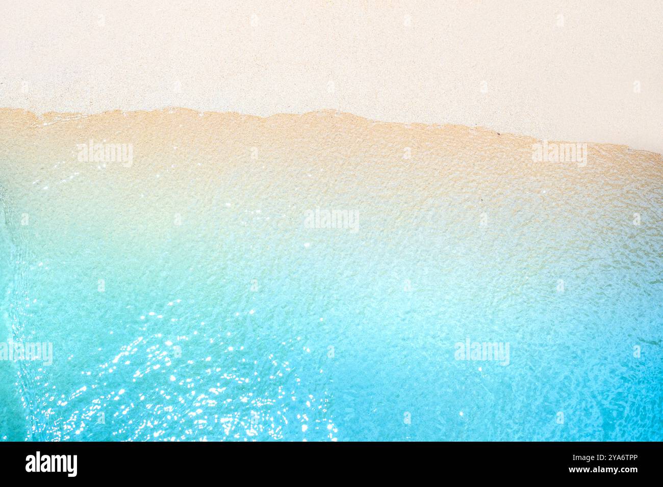Transparent blue sea water on sandy shore, top view. Beautiful natural ...