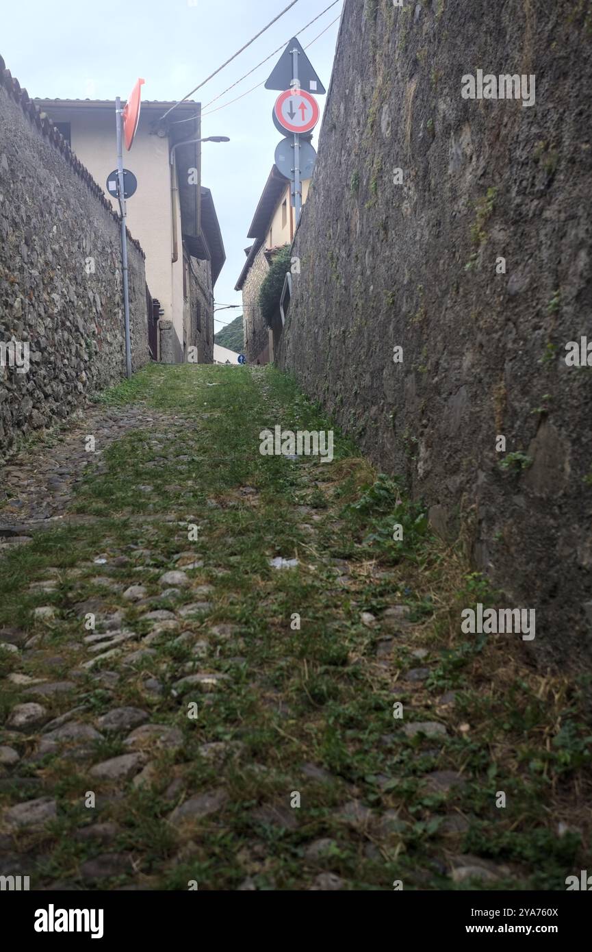 Sloppy cobbled path between a stone walls in a town in the mountains ...