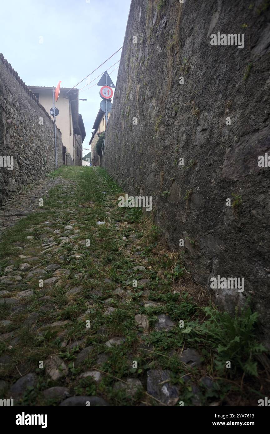 Sloppy cobbled path between a stone walls in a town in the mountains ...
