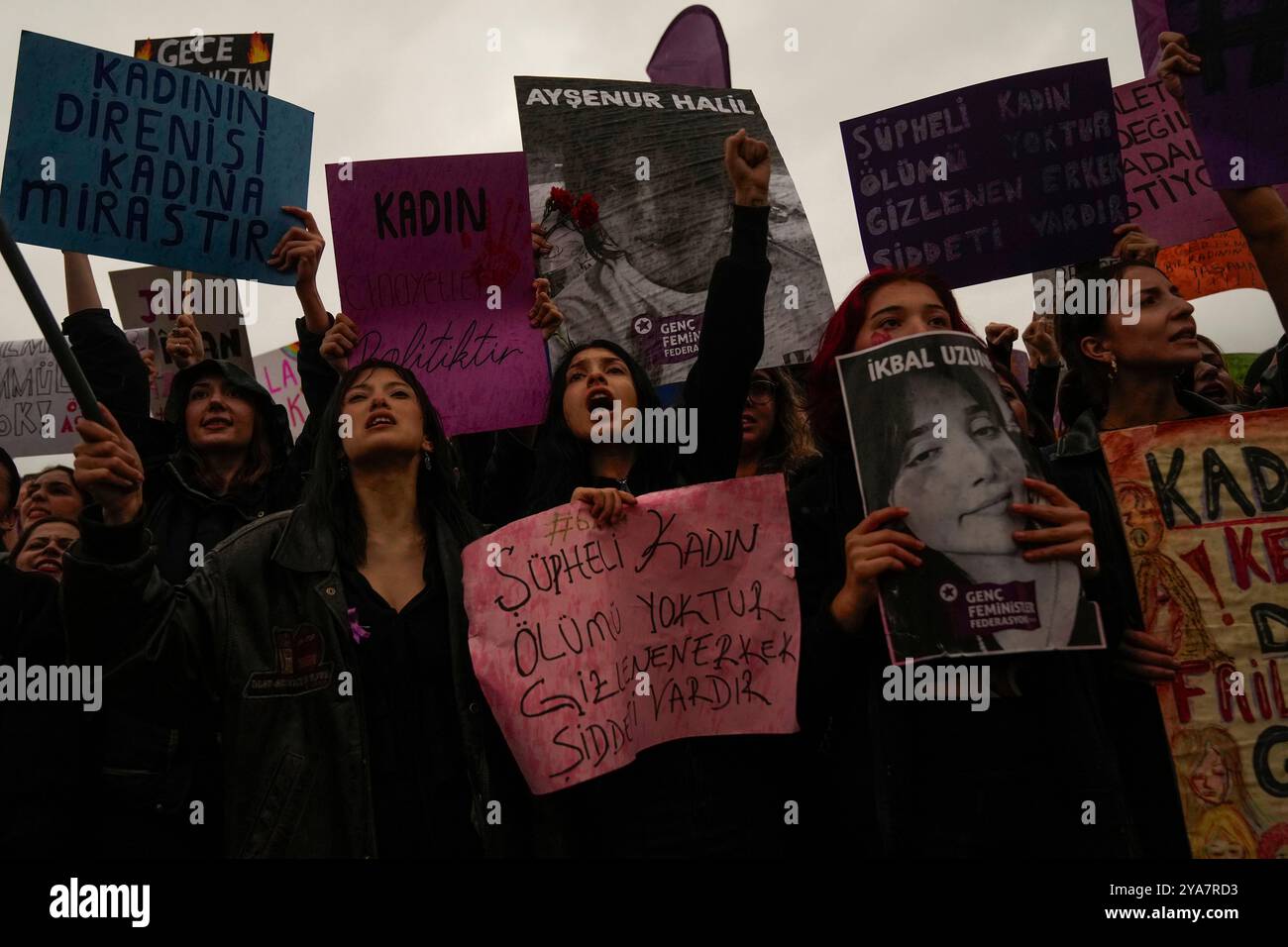 Women hold photographs of Aysenur Halil and Ikbal Uzuner during a ...