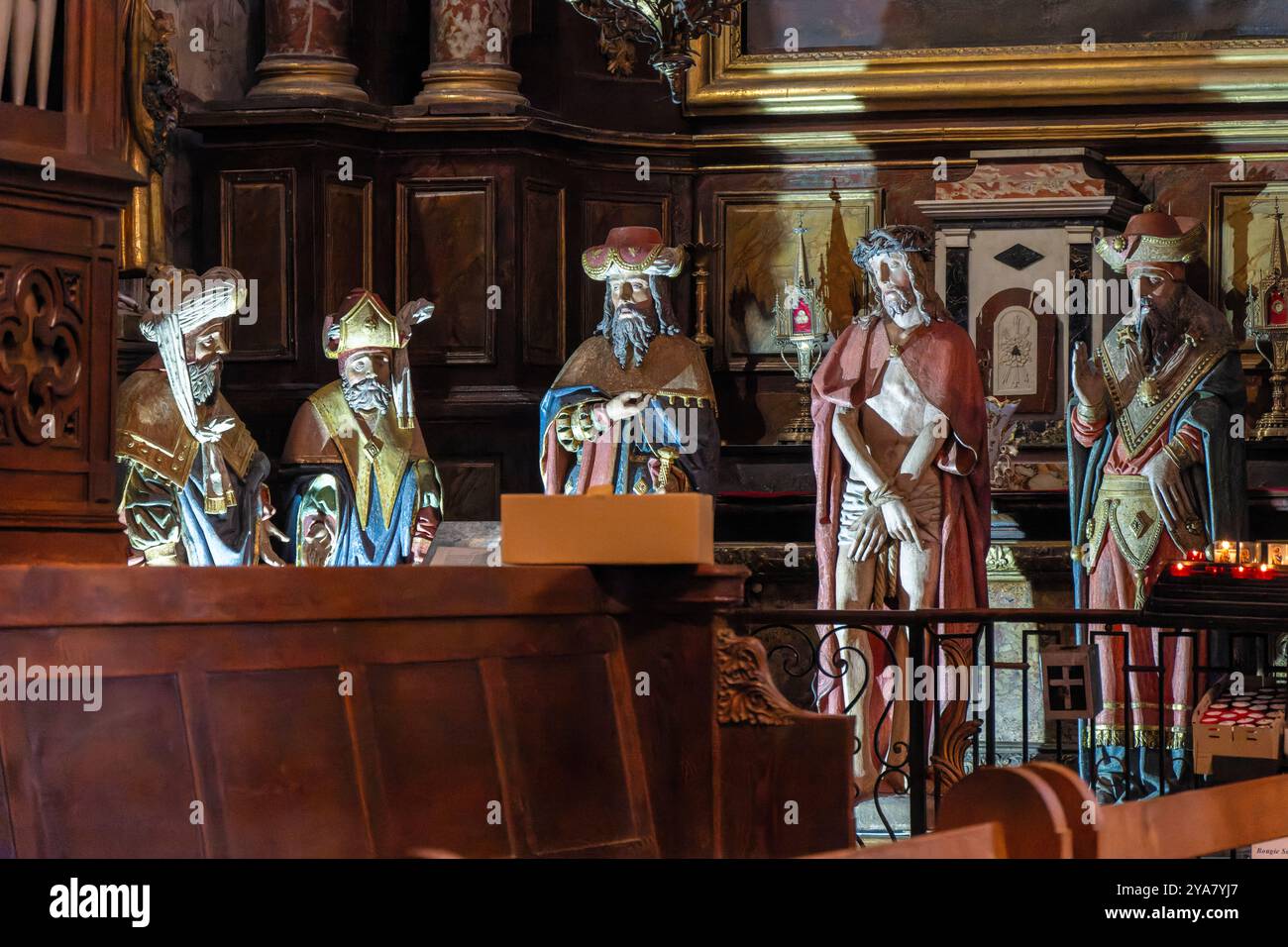 A group of statues of men in religious clothing are displayed in a ...