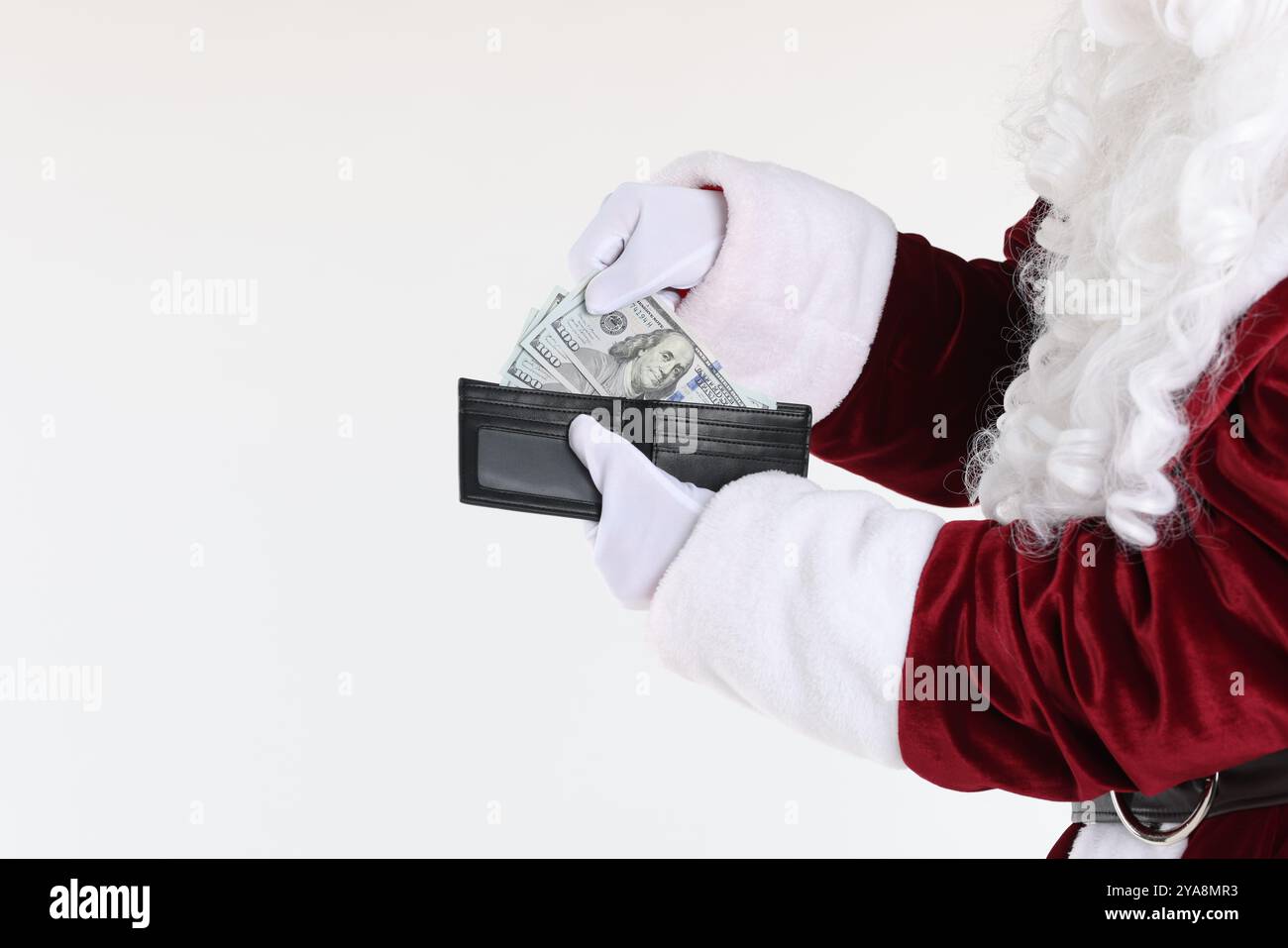Santa Claus taking dollar banknotes out of wallet on white background ...
