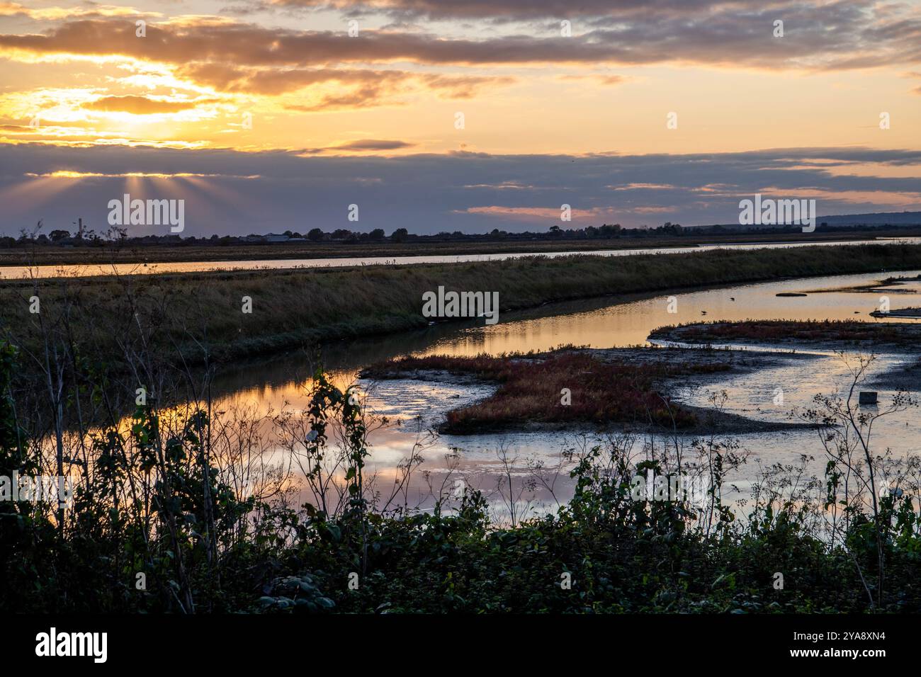Sunset across the lagoon from the RSPB bird hide at Two Tree Island ...