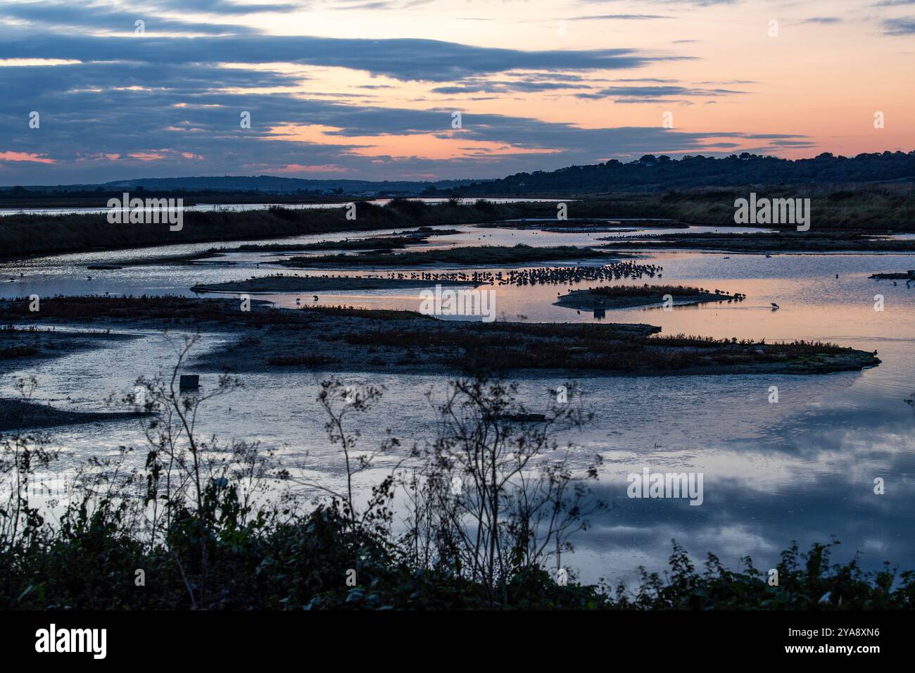 Sunset across the lagoon from the RSPB bird hide at Two Tree Island ...